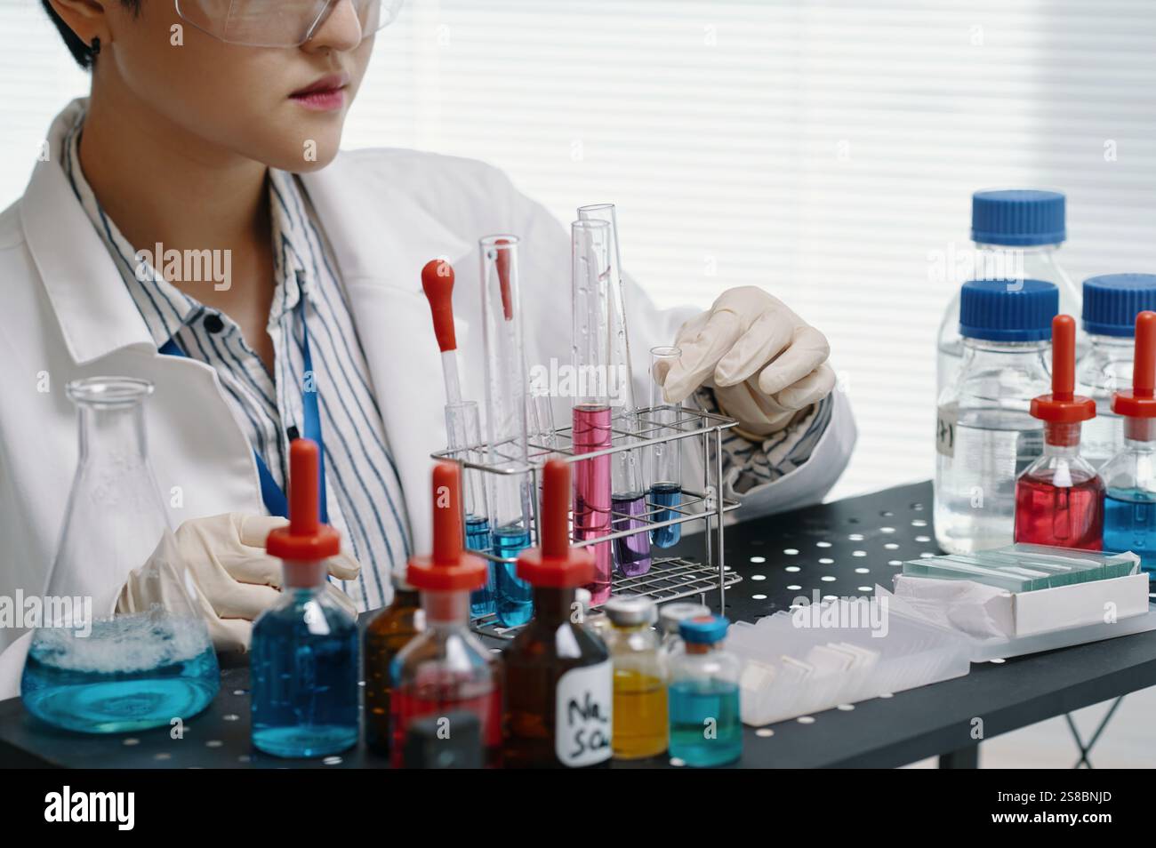 Female scientist chemical solutions hi-res stock photography and images ...