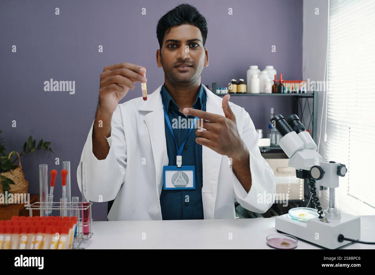 Holding Sample Entering Data In Laboratory Setting Stock Photo - Alamy