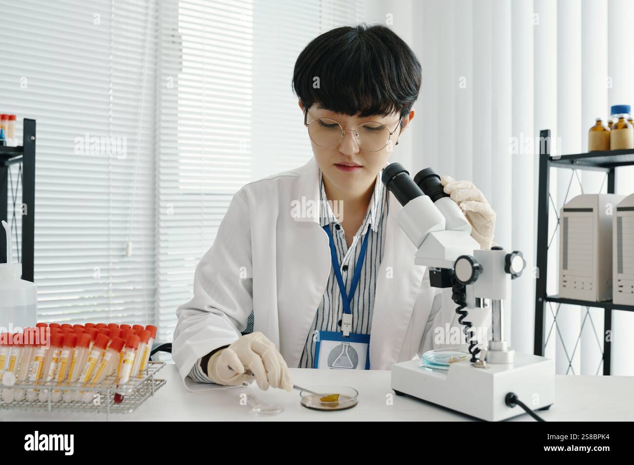 Analyzing Sample Using Laboratory Microscope in Laboratory Setting ...