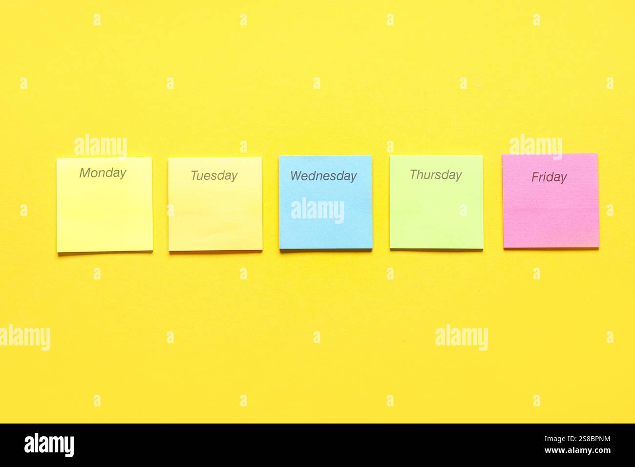 Different blank sticky notes with names of weekdays on yellow ...