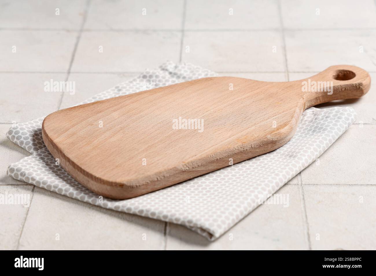 Empty cutting board with napkins on white tiled table, closeup Stock ...