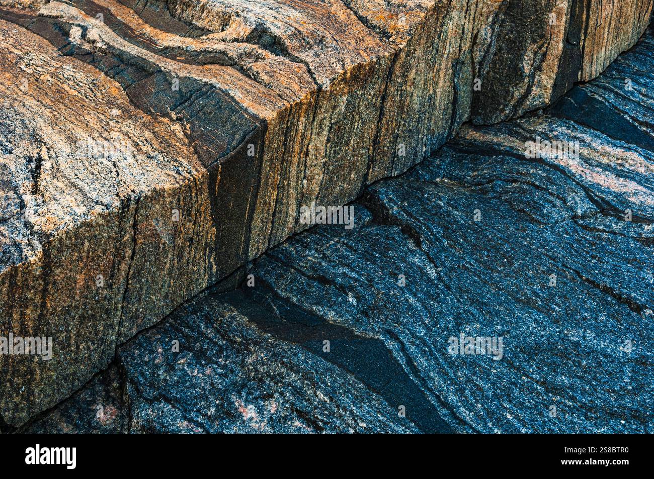 Colorful rock formations border a body of water, showcasing intricate ...