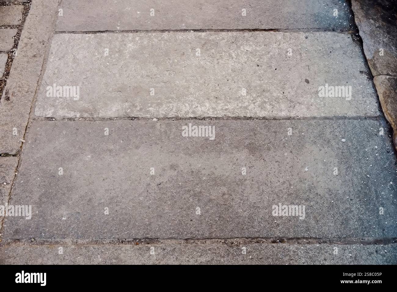 Cremona, Italy - January 15th 2025 Concrete sidewalk with a lighter ...