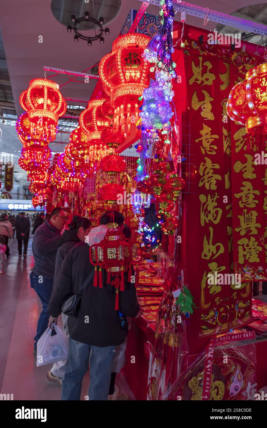 People select Spring Festival decorations at a market in Jilin City ...