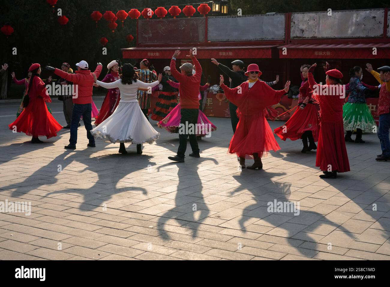 A dances as part of morning exercises in front of red lanterns at Ditan ...