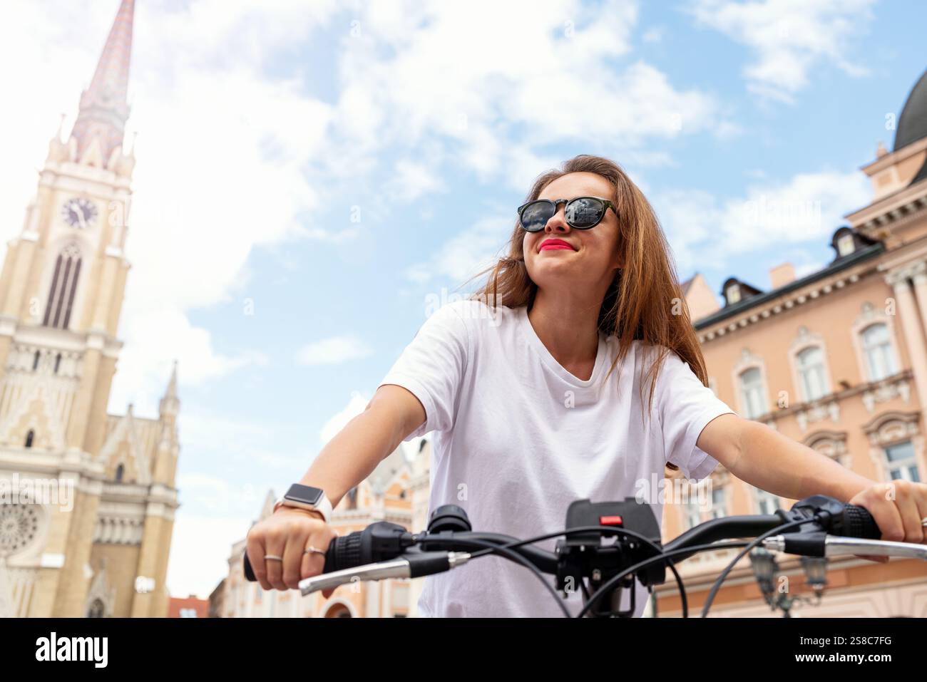 Sustainable cycle-tourism. Young urban woman traveling by bicycle ...
