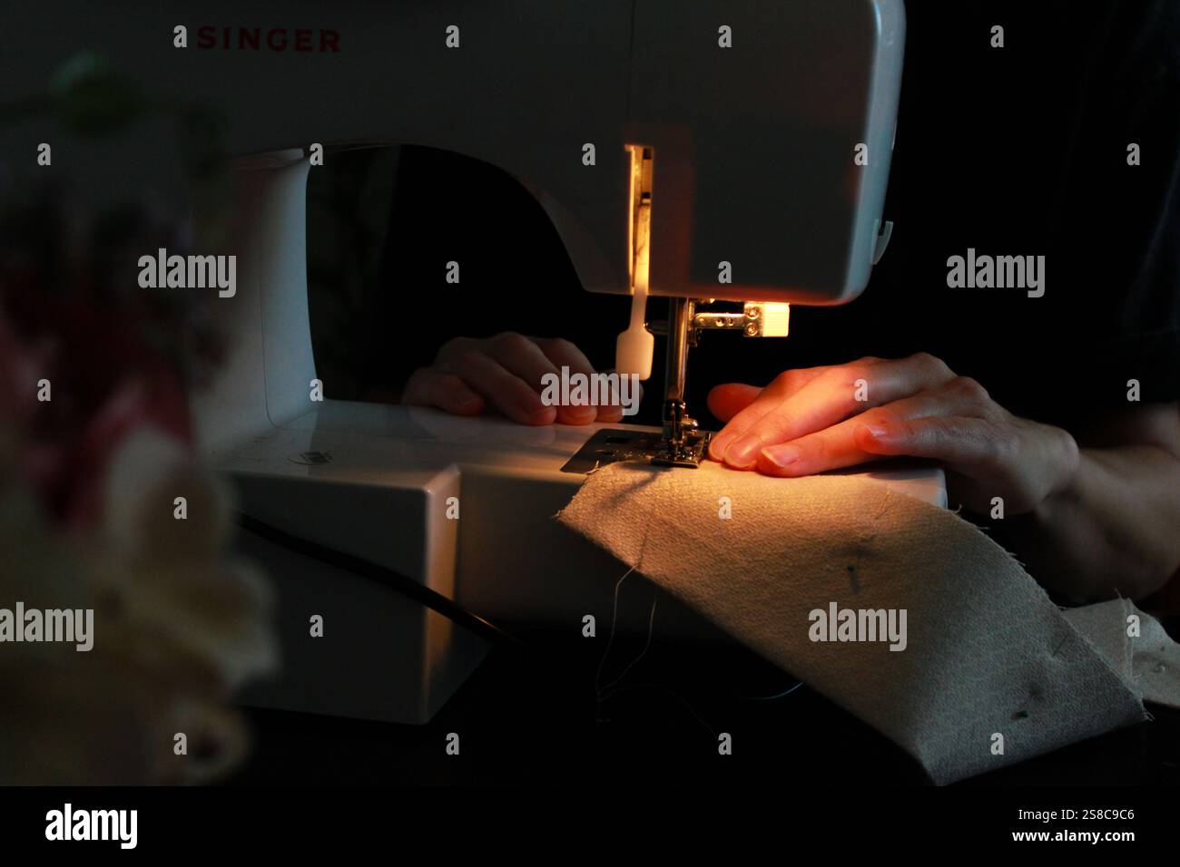 A vintage white Singer sewing machine, featuring the brand name in ...