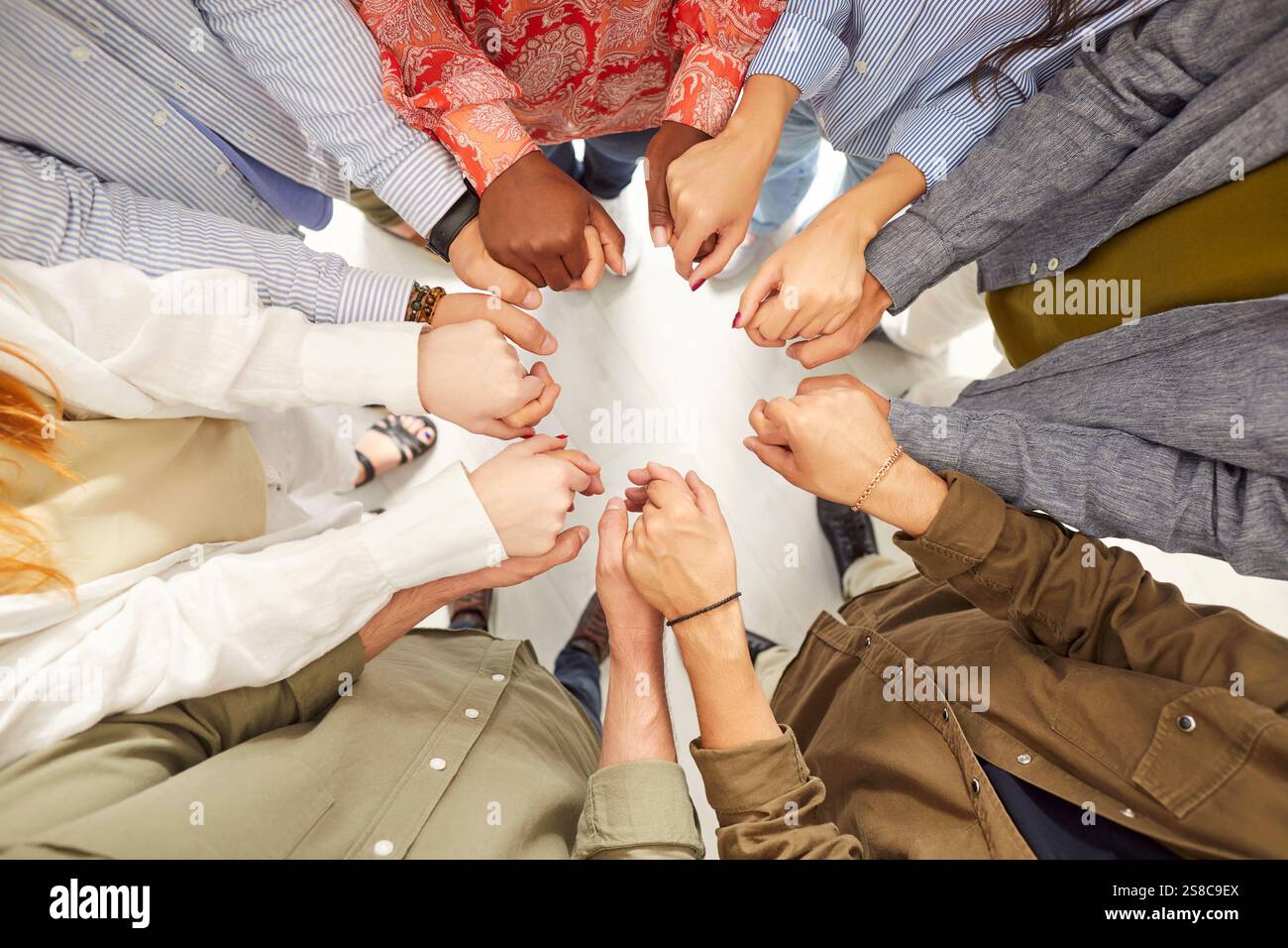 Top view of people group or students putting arms together in a circle ...