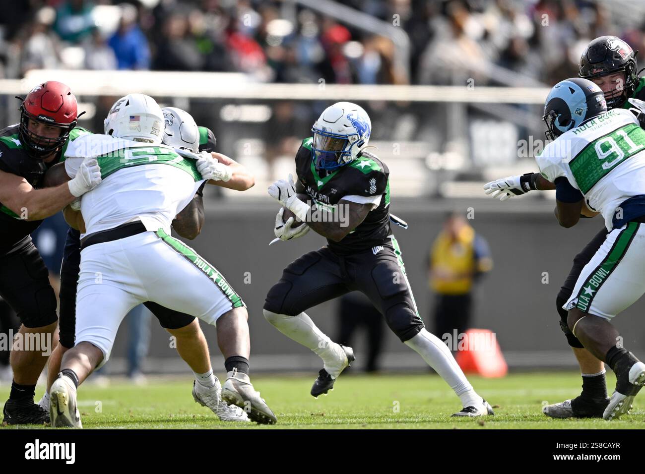 Team Aina running back Mario Anderson, center, of Memphis, rushes for ...