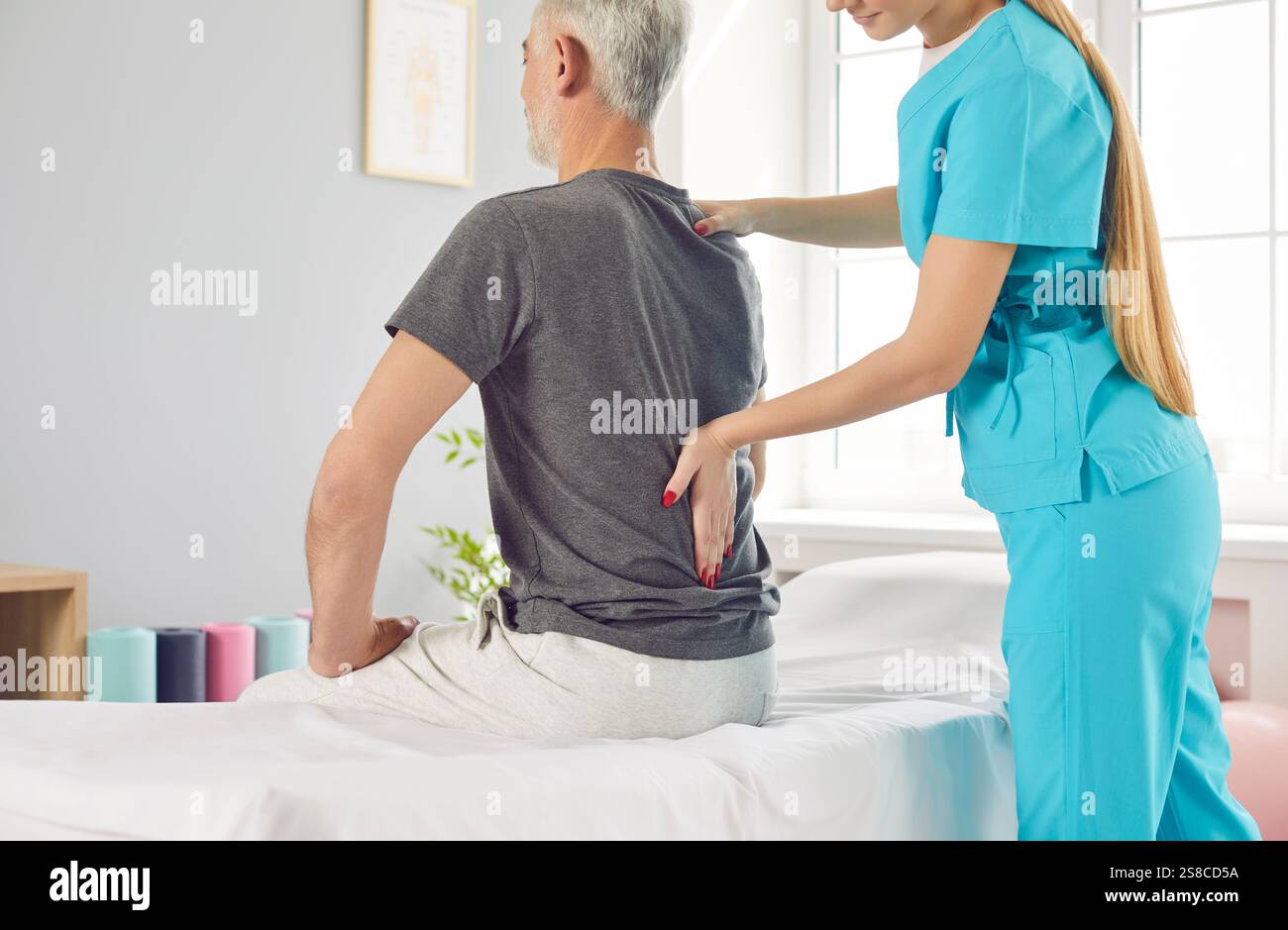 Physiotherapist Massaging Elderly Patient Back During Rehabilitation ...