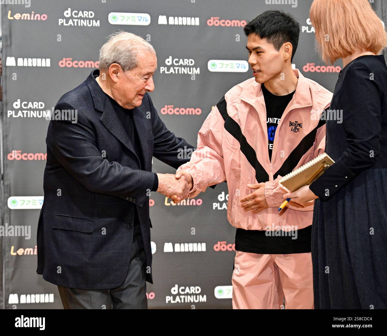 South Korea's Kim Ye-joon (R) shakes hands with promoter Bob Arum ...