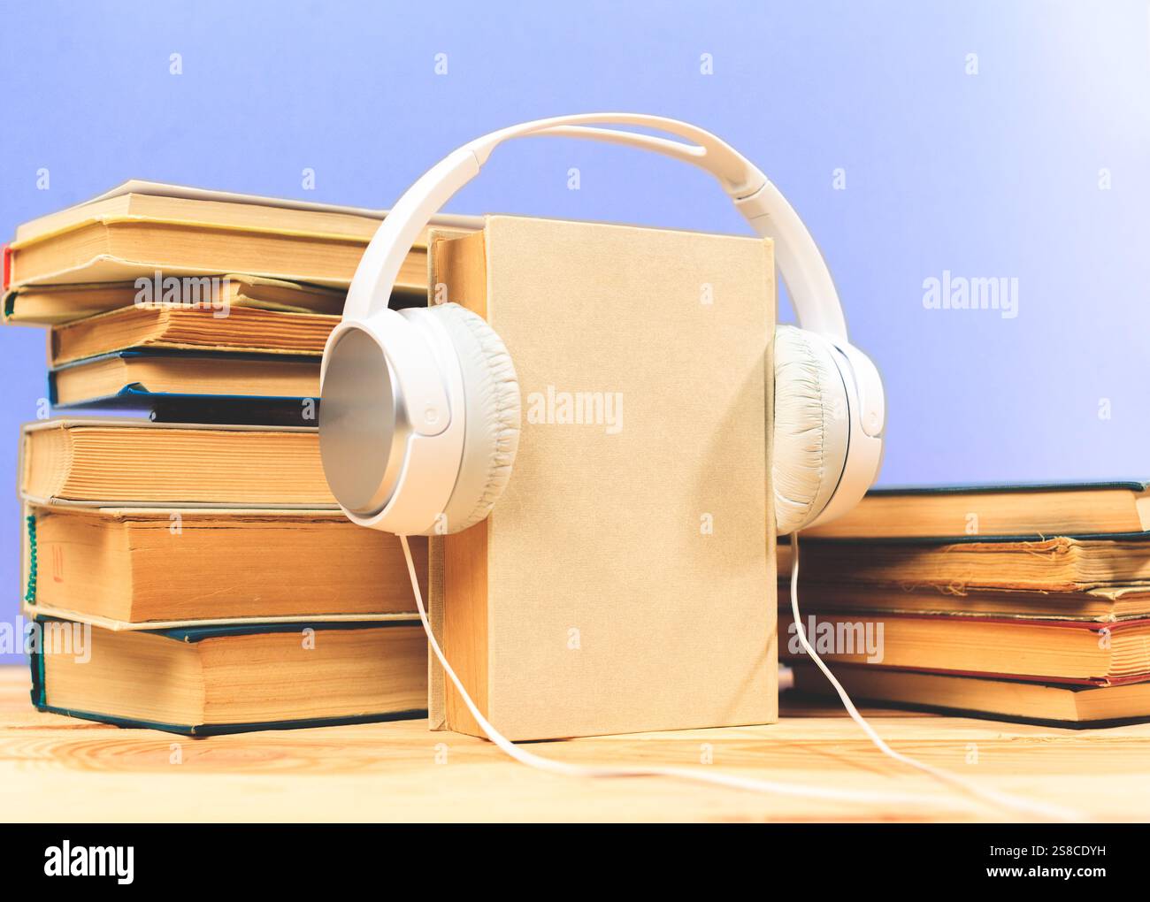 Books on the table with headphones put on them Stock Photo - Alamy