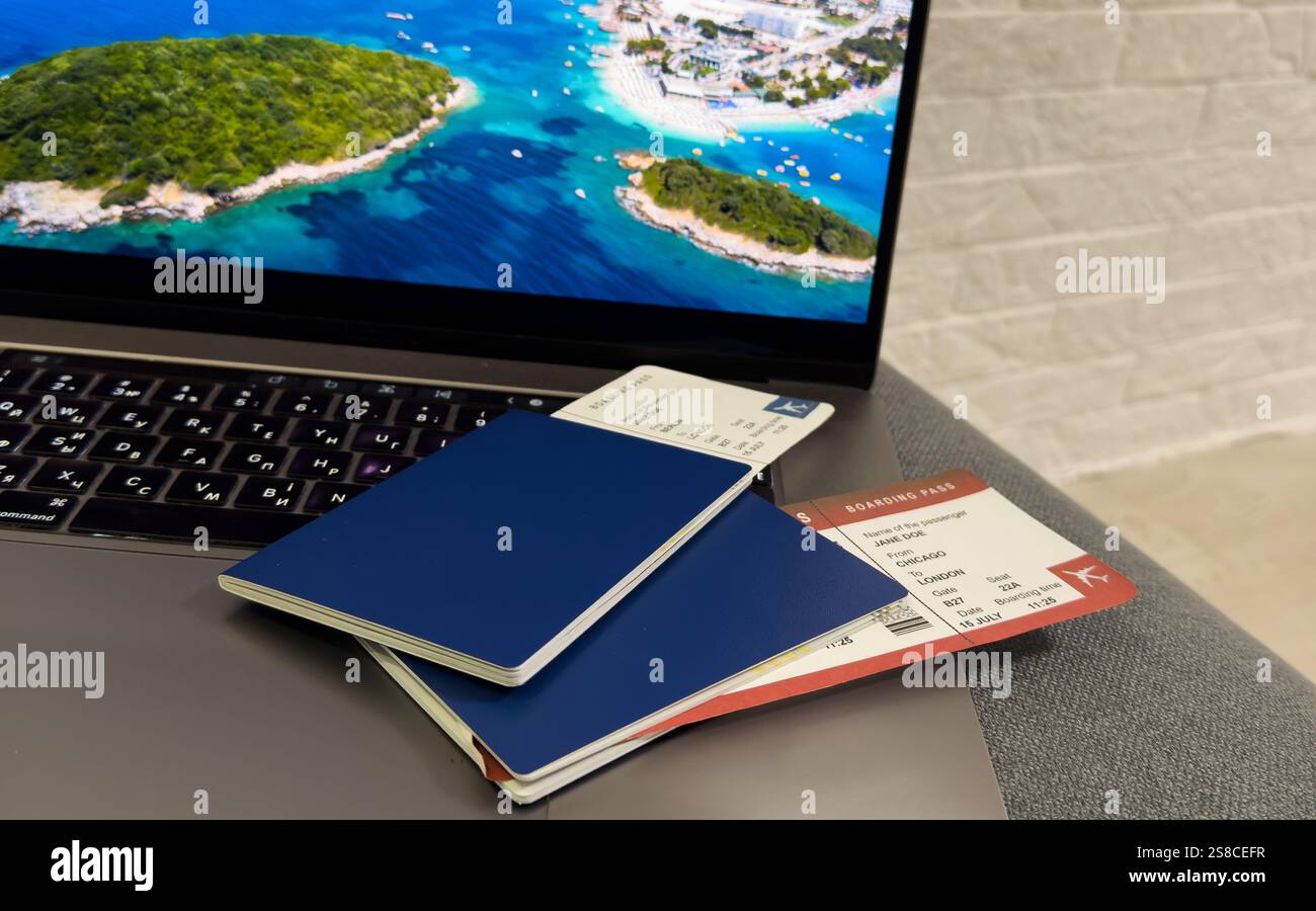 Airline boarding passes with passport, laptop Stock Photo - Alamy