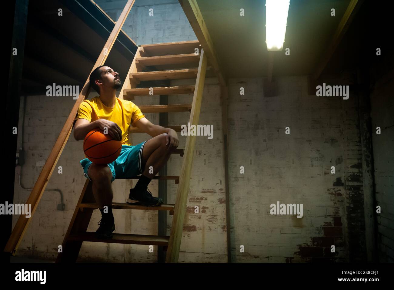 A Reflective Basketball Player Engaged in Thought Within a Vibrant ...