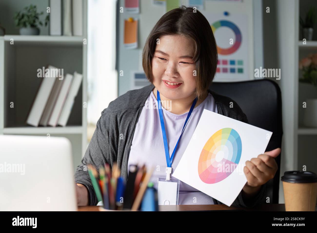 Enthusiastic graphic designer showcasing a color wheel and discussing ...