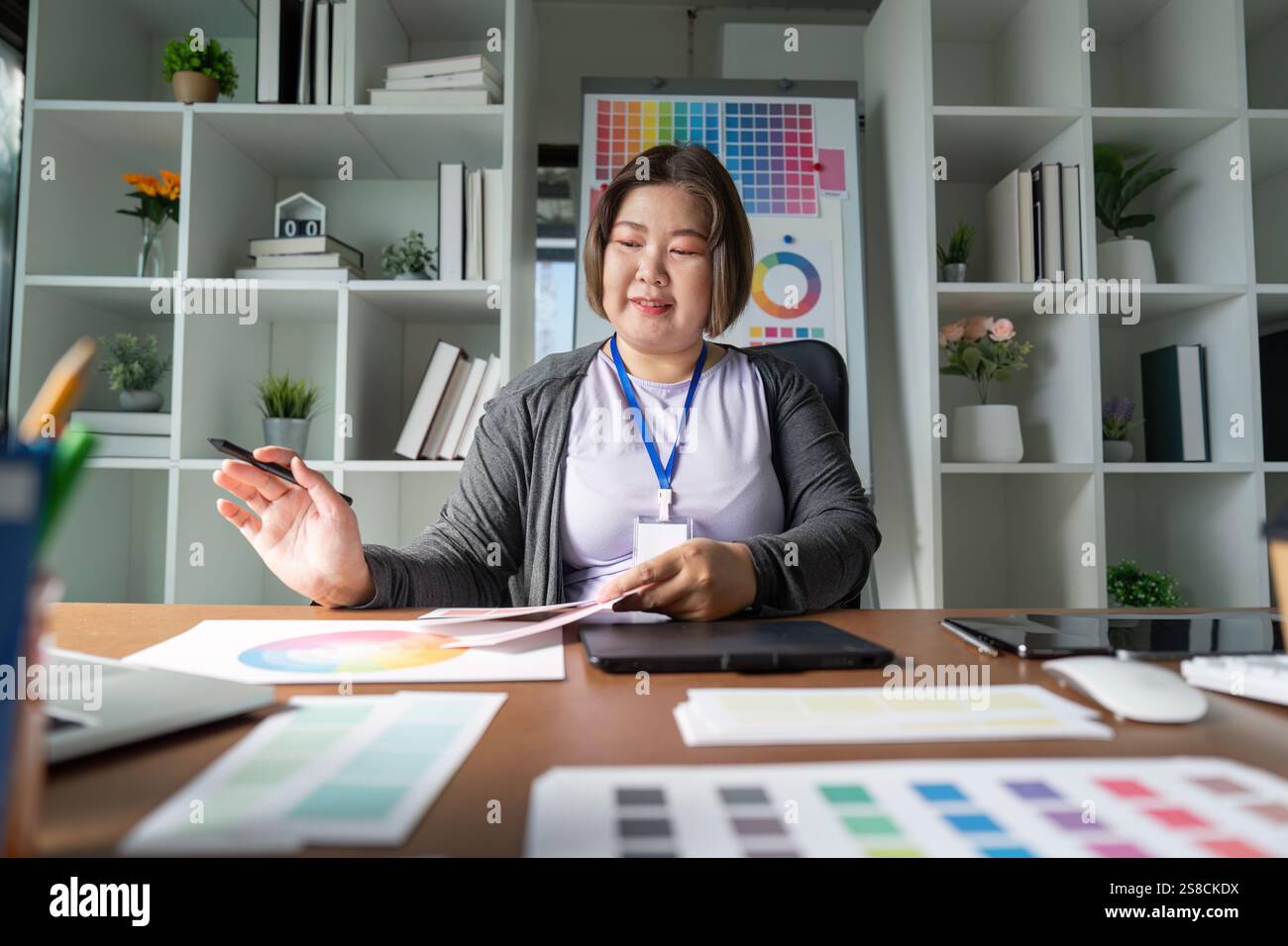 Graphic designer presenting color scheme options while sitting at her ...