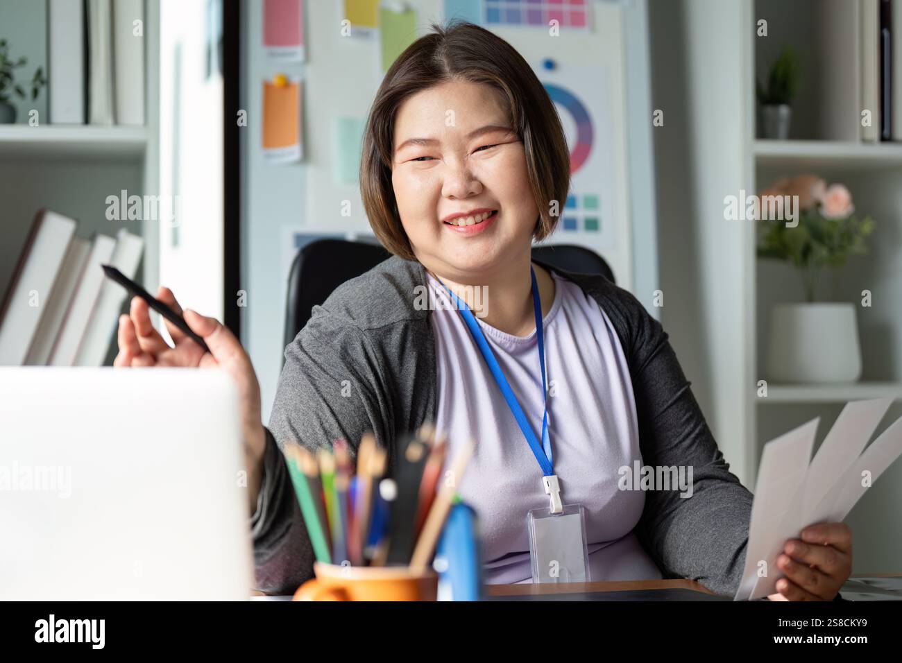 Smiling graphic designer presenting design ideas in a creative ...