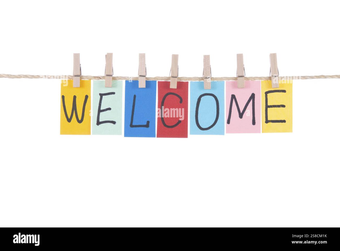 Welcome, paper words card hang by wooden peg Stock Photo - Alamy