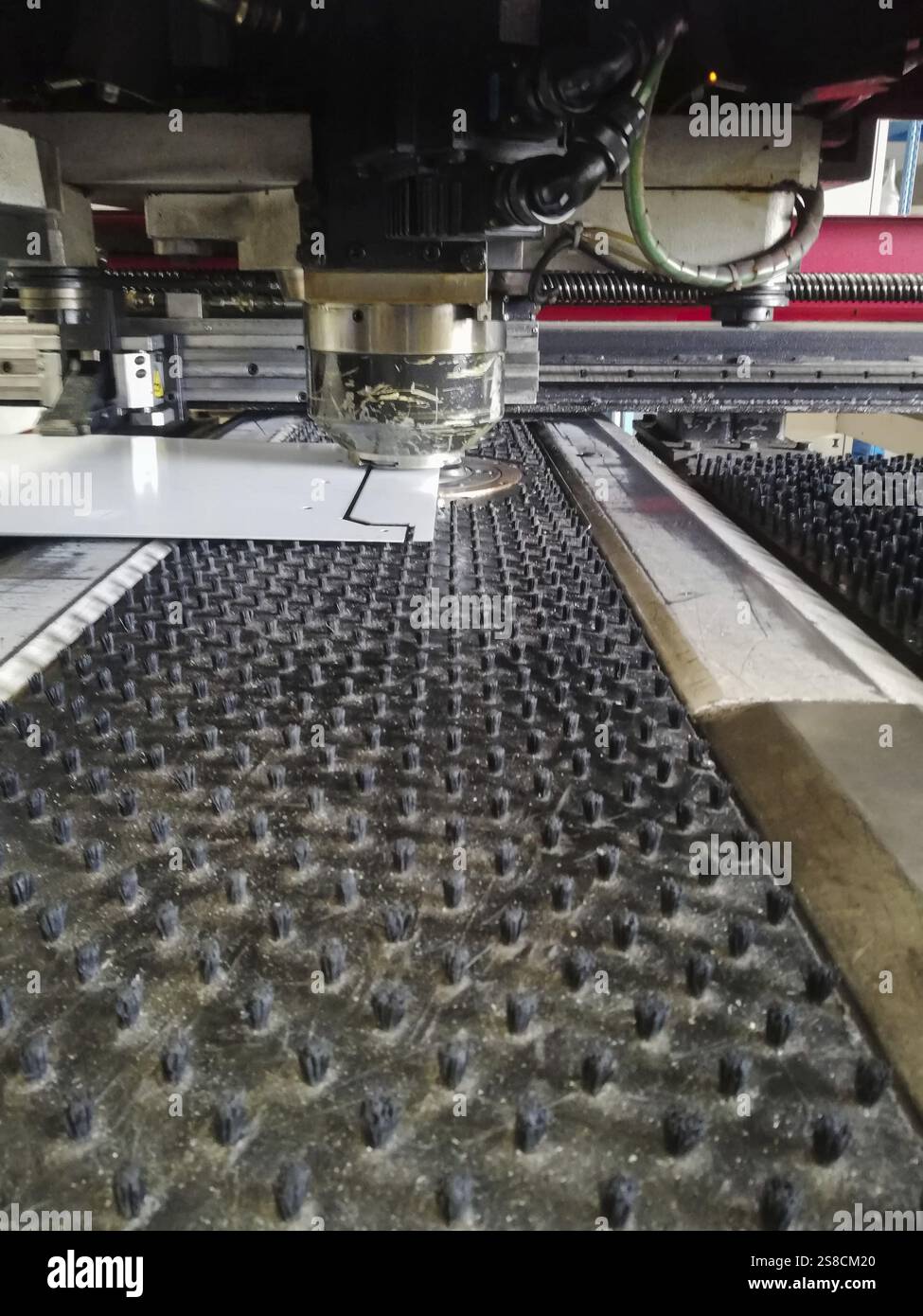 Rotation CNC Punching & Nibbling Machine in action. Metal perforating ...