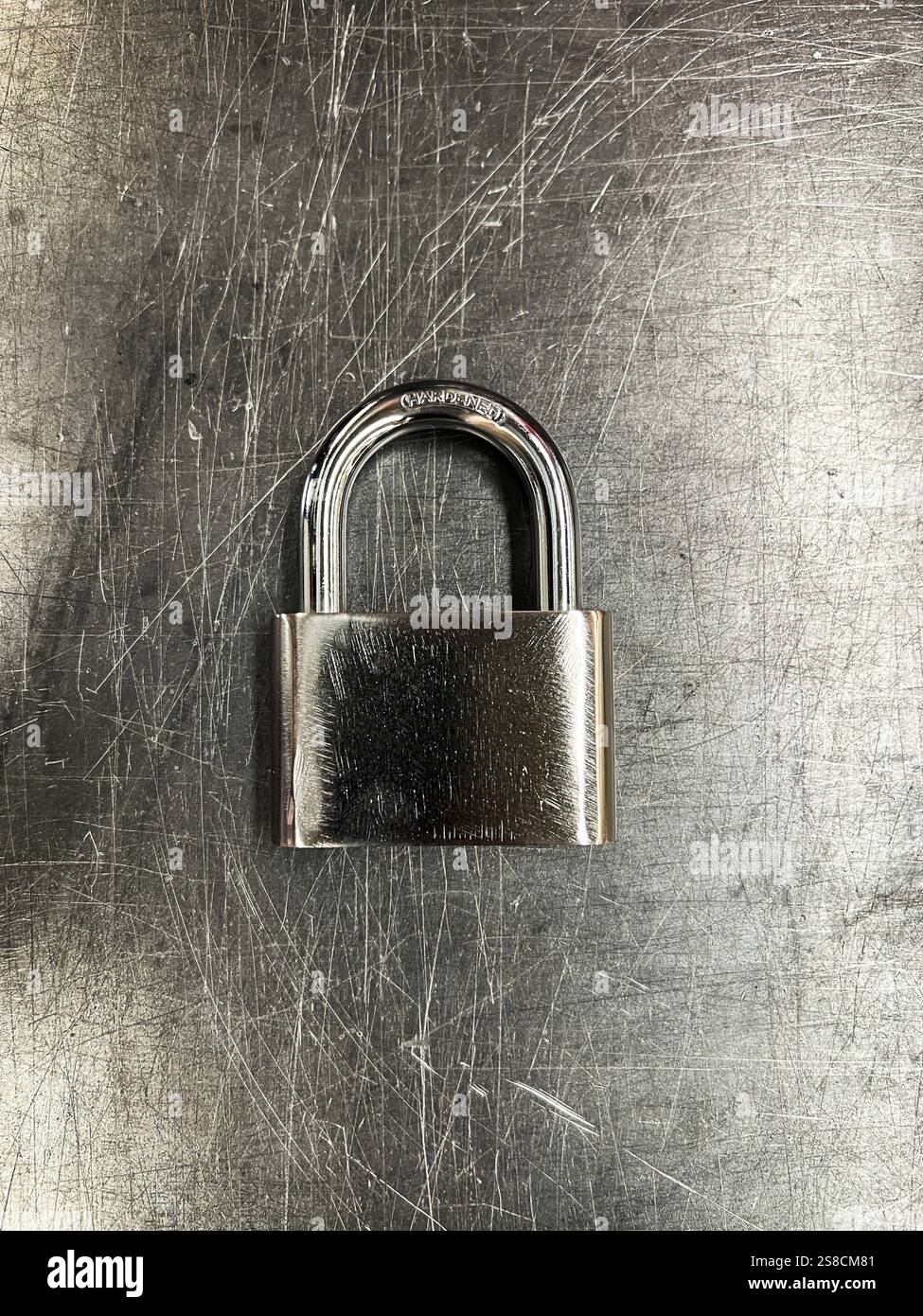 Metallic padlock on metal texture background Stock Photo - Alamy
