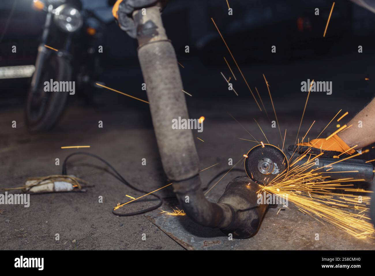 Cutting out a catalytic converter from a car muffler valuable metals ...