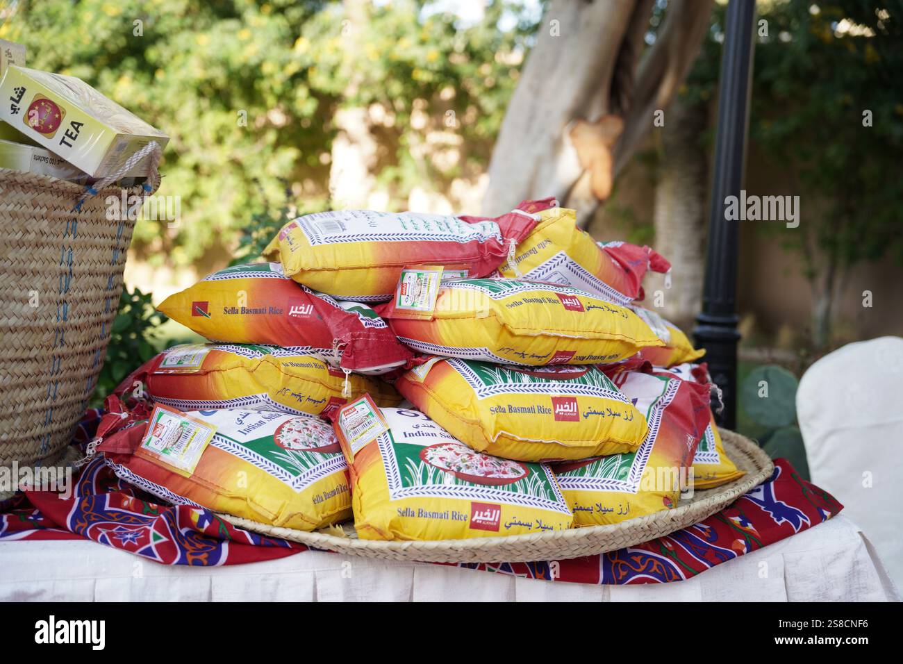 A vibrant stack of Sella Basmati Rice bags displayed outdoors. The ...