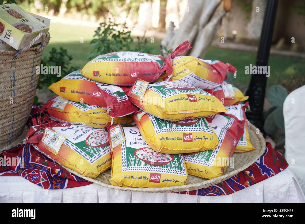 A vibrant stack of Sella Basmati Rice bags displayed outdoors. The ...