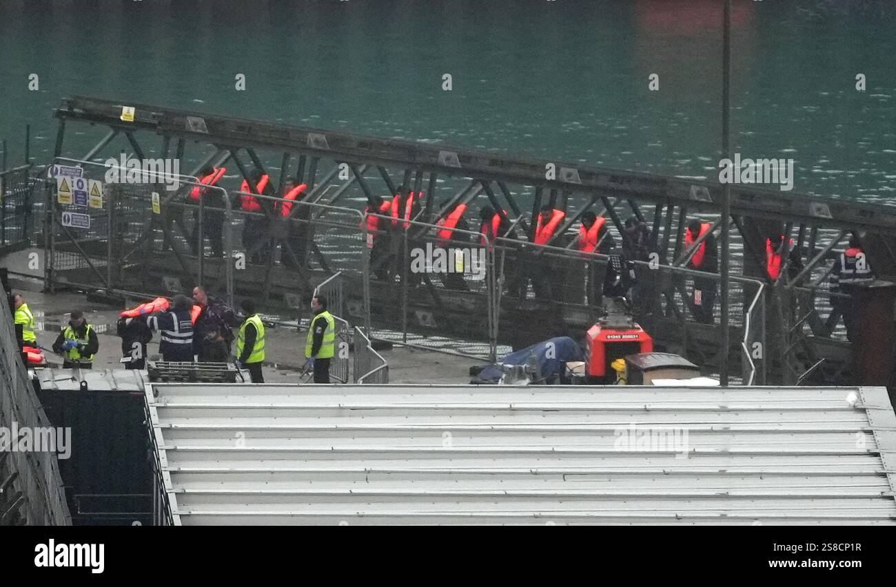 A group of people thought to be migrants are brought in to Dover, Kent ...