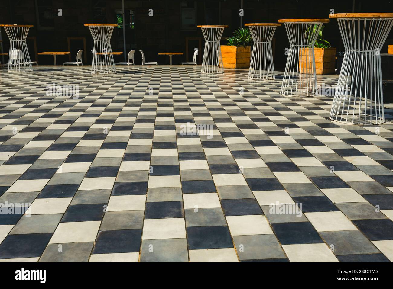 An outdoor bar area with a checkerboard floor (repeating pattern) and ...