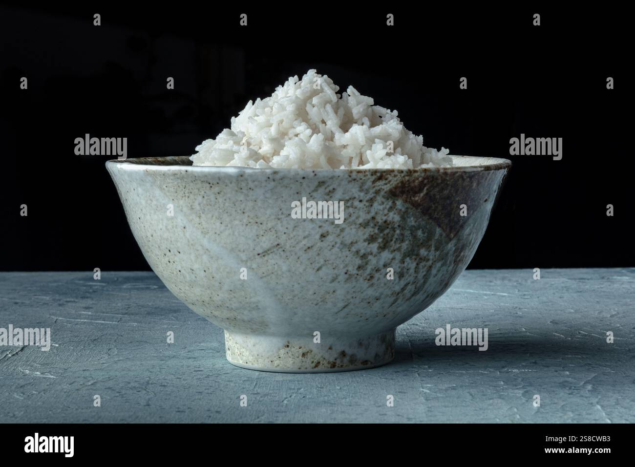 White rice, cooked. A bowl of boiled long grain rice, a simple side ...