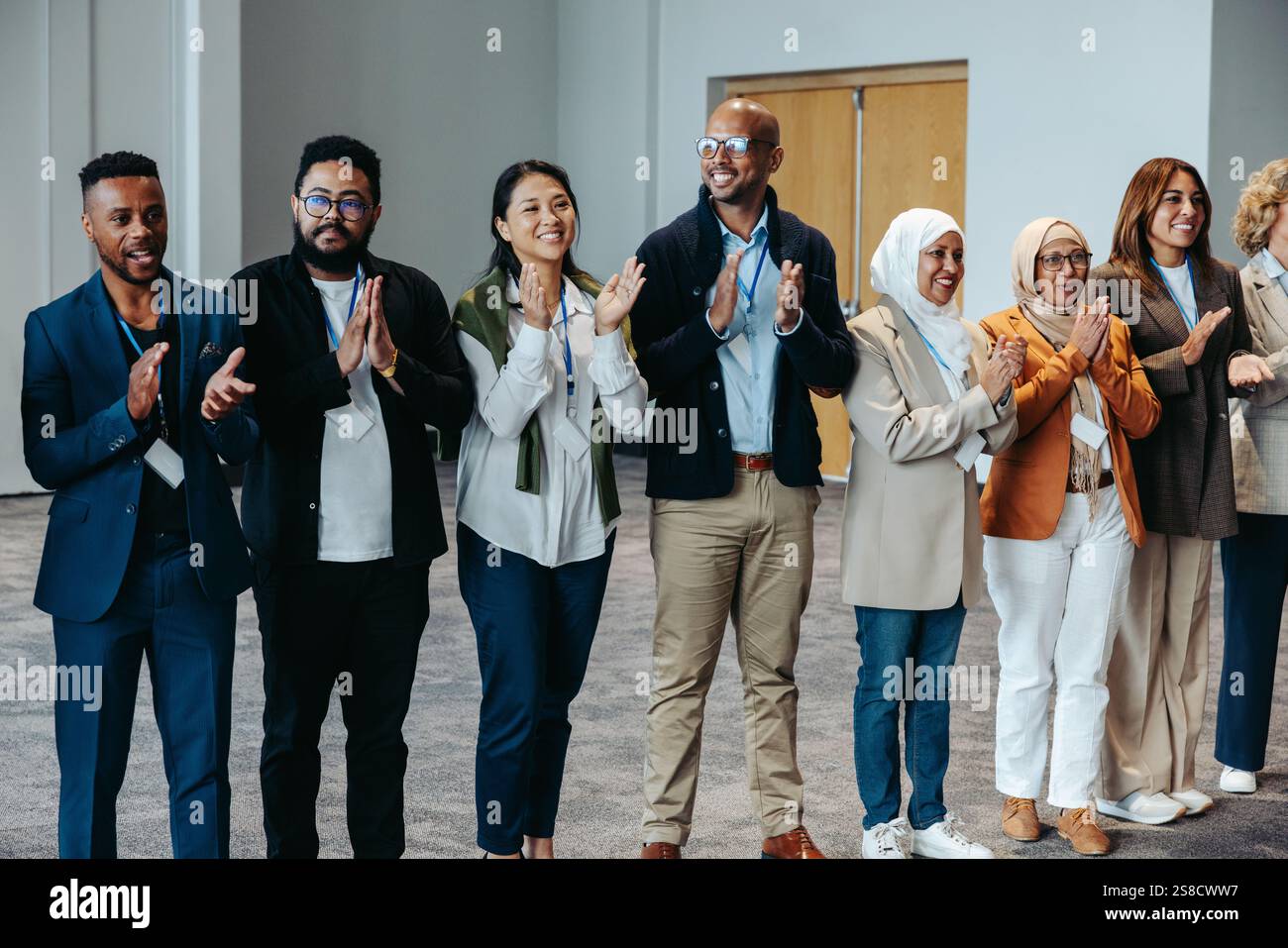 A diverse group of skilled colleagues applauding during a training ...