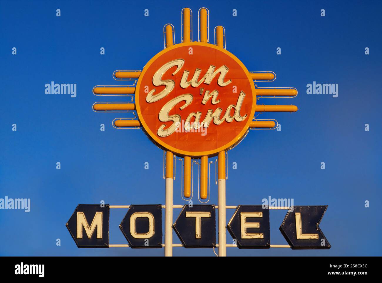 Zia Pueblo sign for sun, state symbol at Sun'n Sand Motel neon sign, in ...