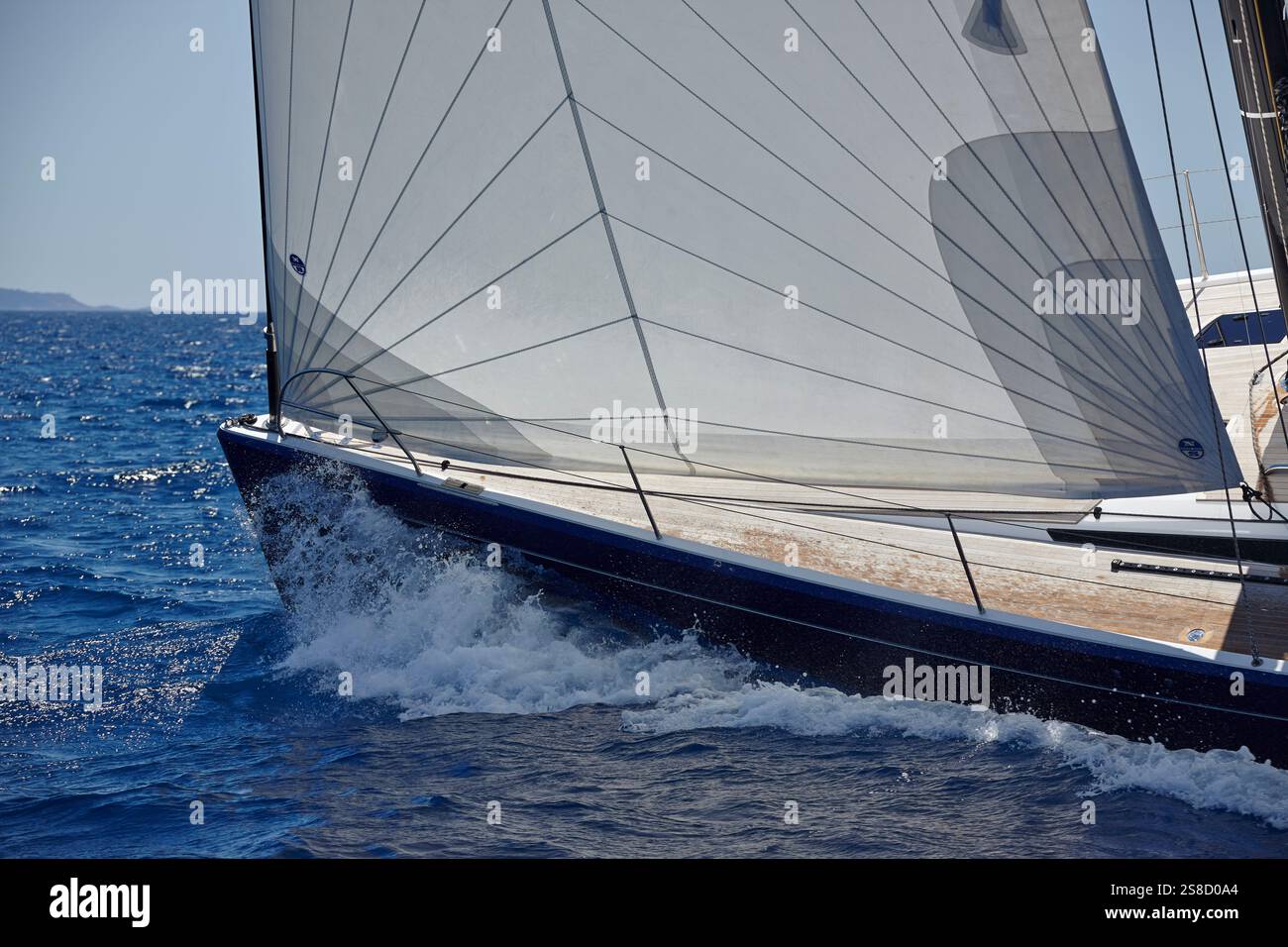 The Bow of an Elegant Sailboat Cutting Through Waves on a Bright Sunny ...