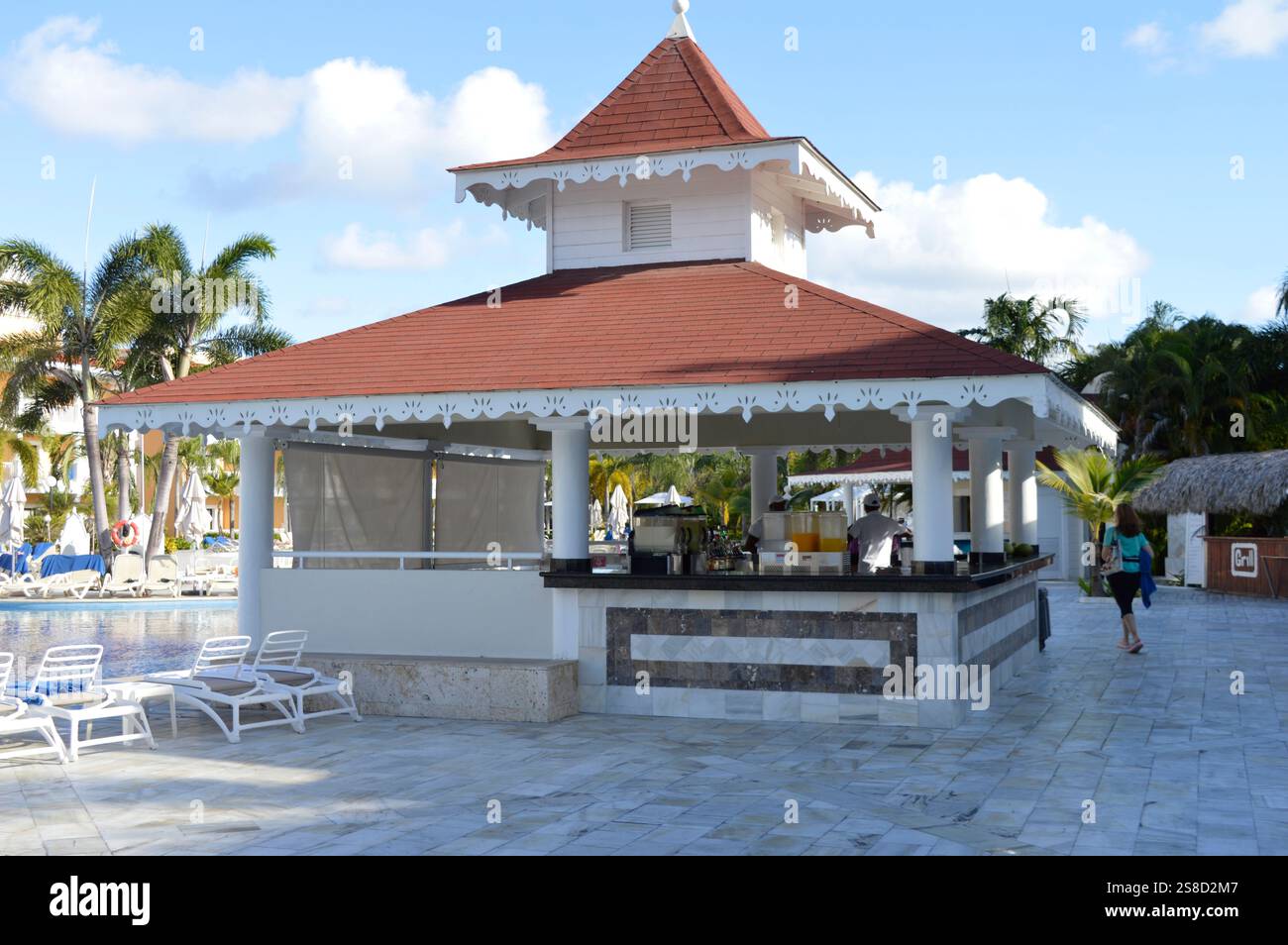 A cabana in the Caribbean set poolside being set up for the day's ...
