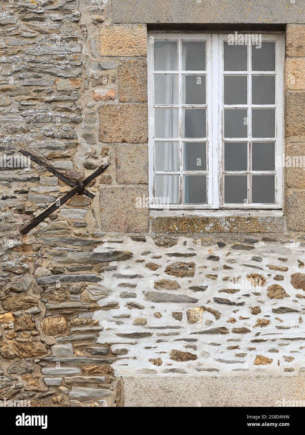 202 Rusty iron, X-shaped anchor plate on the masonry wall of a stone ...