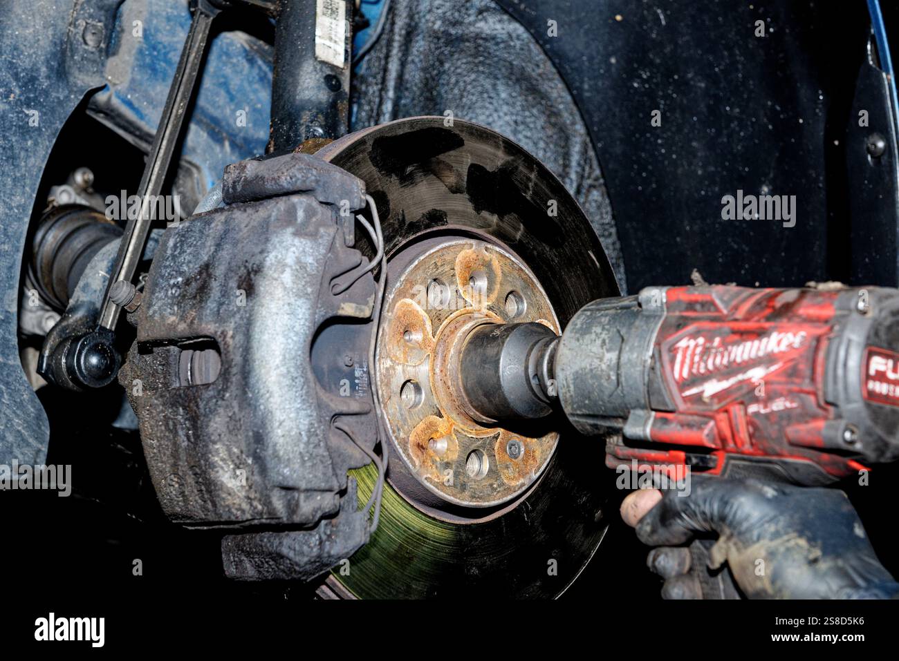 Car brakes. Work in car repair shop. Brake disc after removing the ...