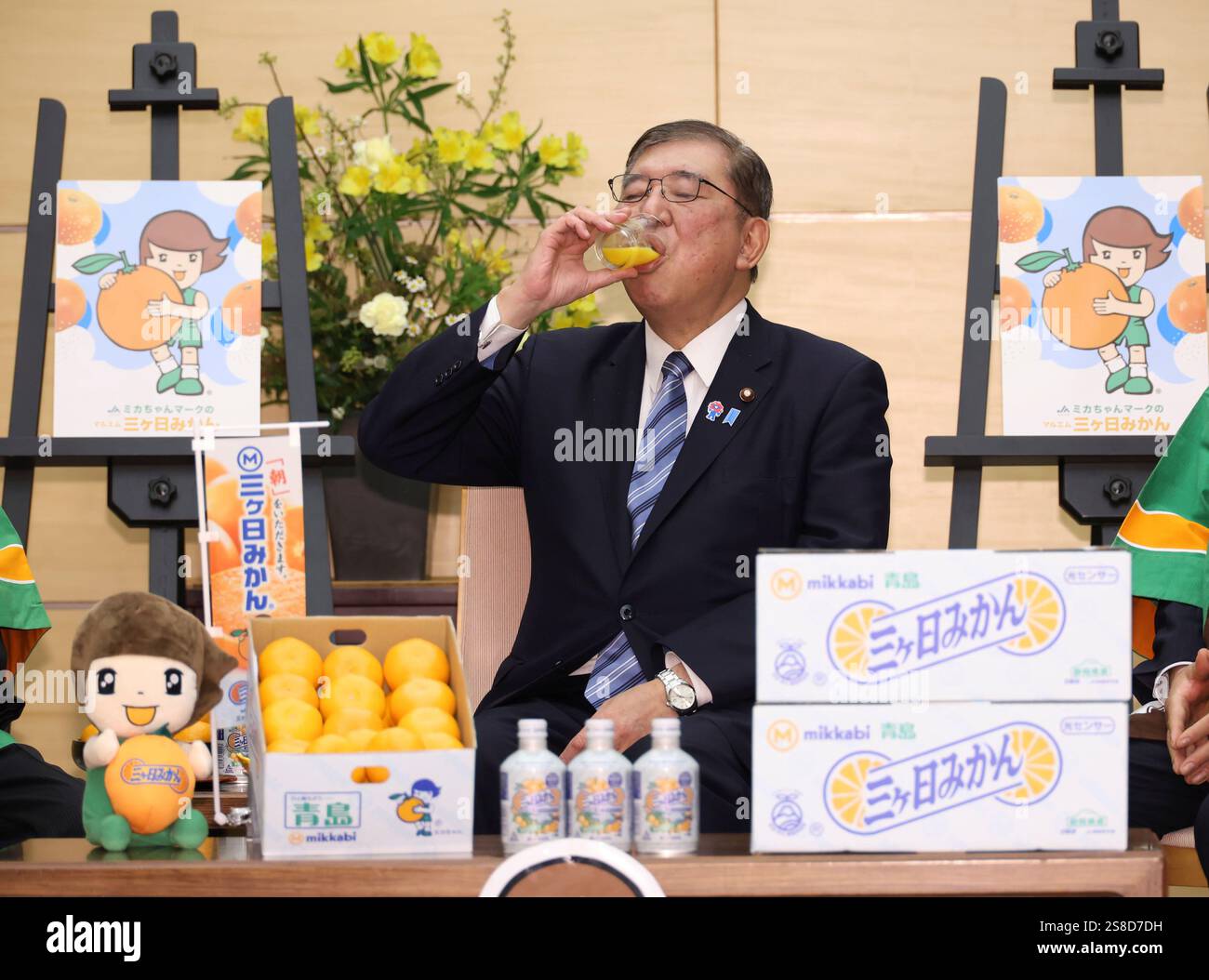 Japan's Prime Minister Shigeru Ishiba tastes mandarin oranges during a ...
