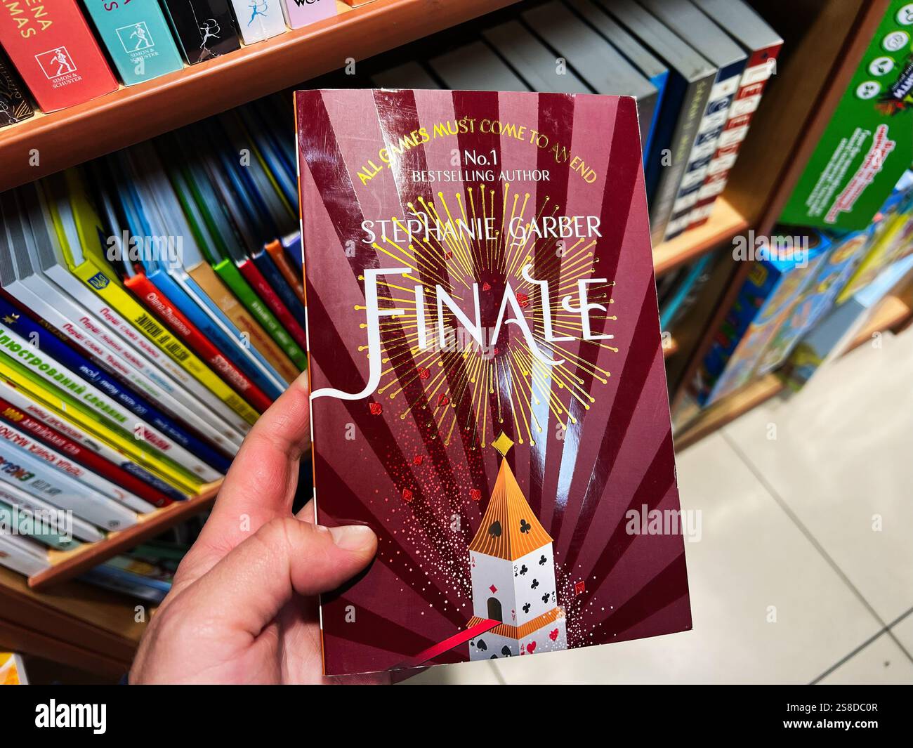 Kyiv, Ukraine - January 21, 2025: A person browsing a library holds ...