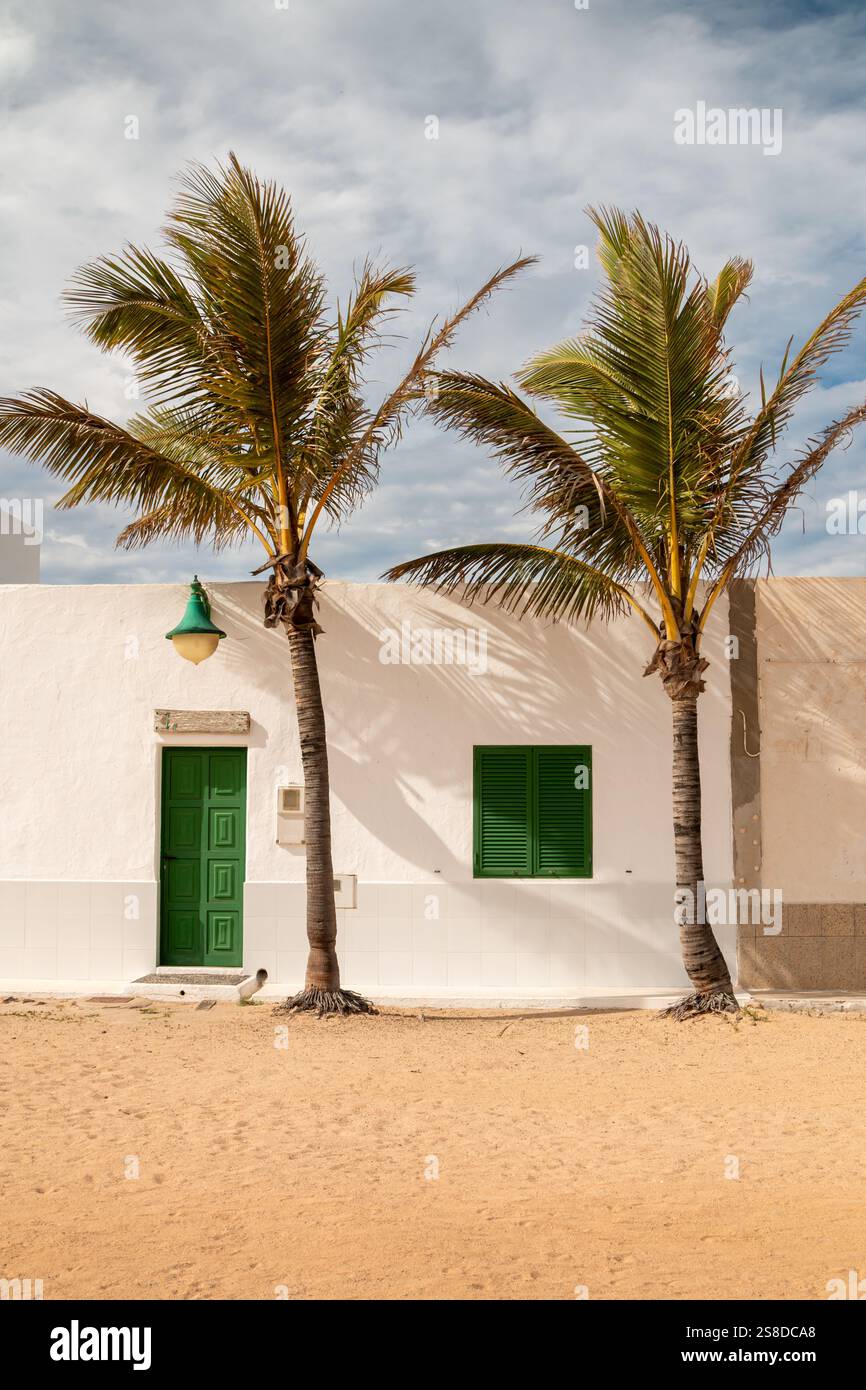 Sandy street on the coast of the Atlantic ocean. House with white ...