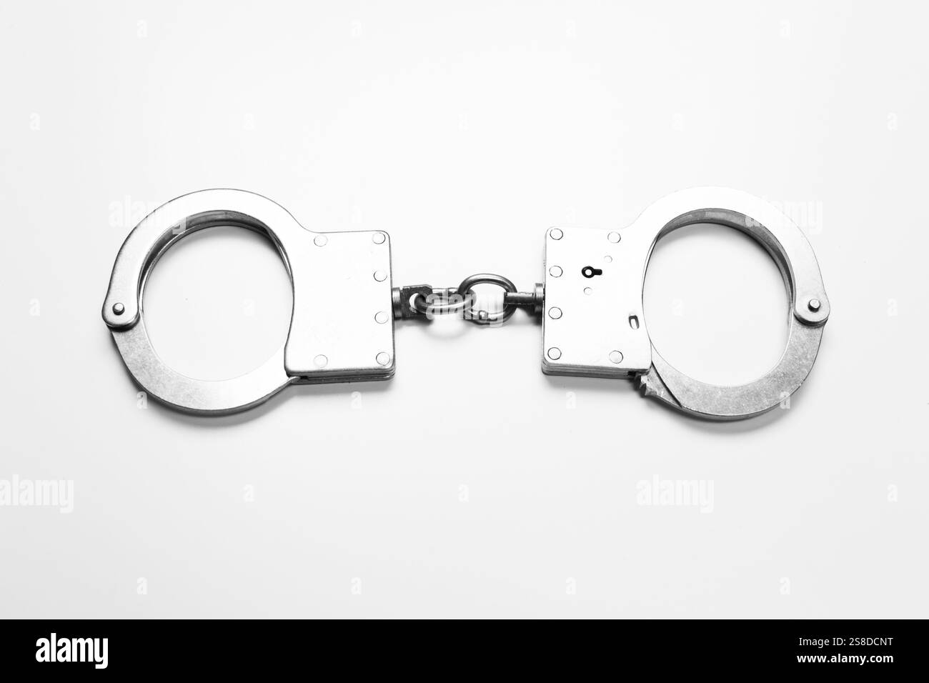 Closed handcuffs white background Black and White Stock Photos & Images ...