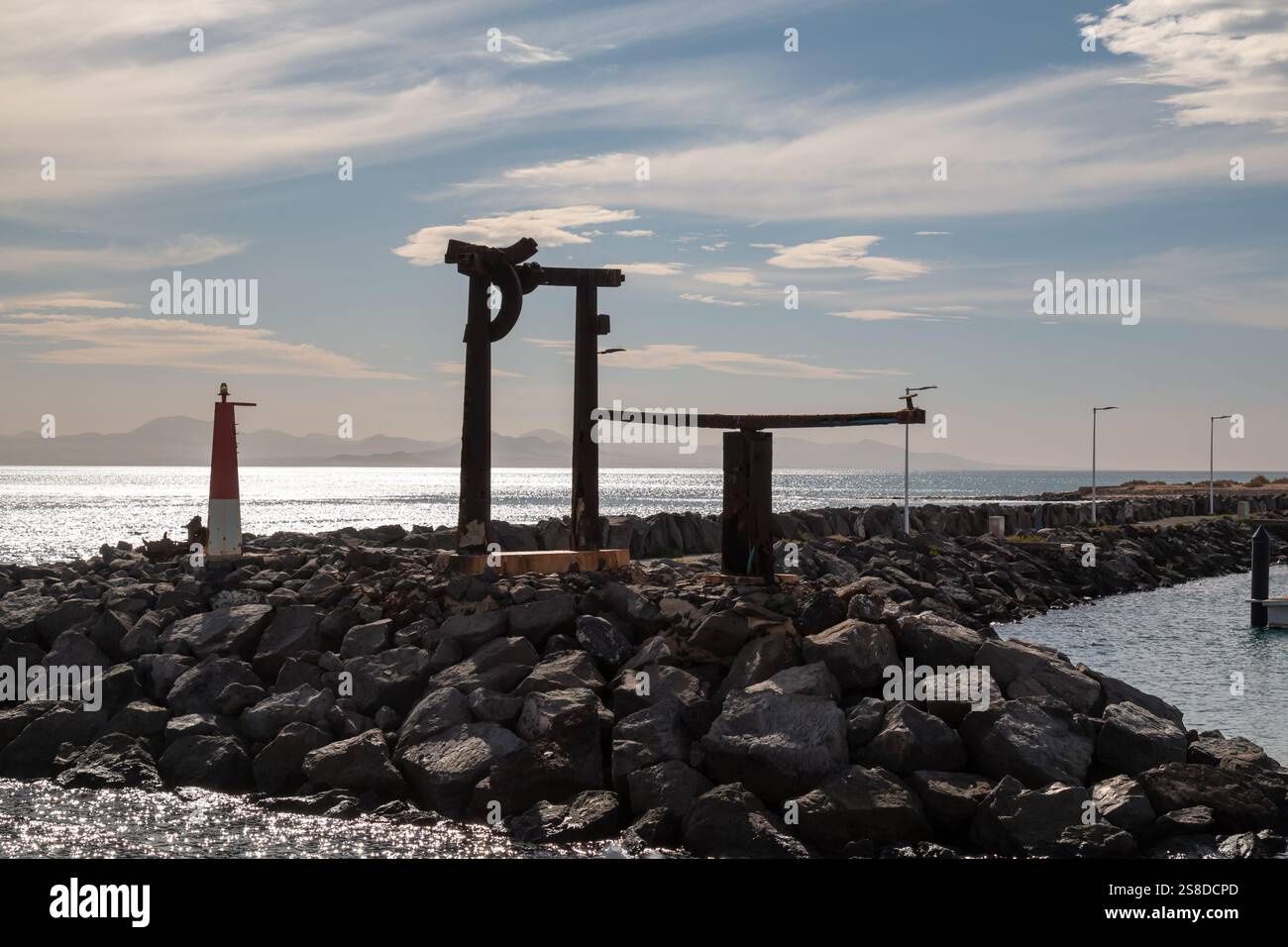 Pier made of volcanic rocks, creating a bay at the entrance/exit of a ...