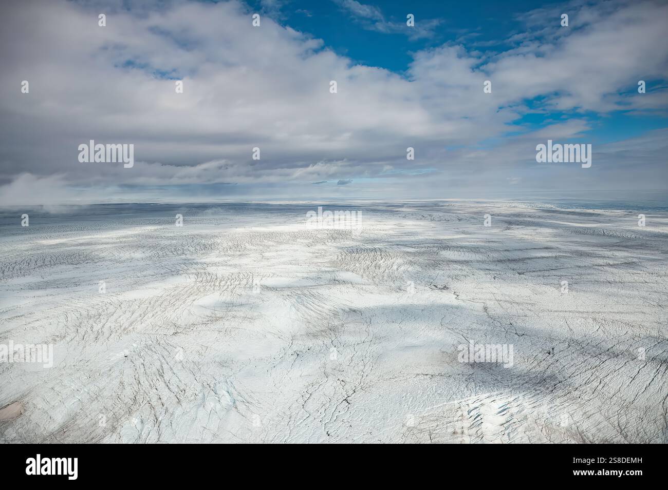 The Greenland ice sheet stretches endlessly, displaying intricate ...