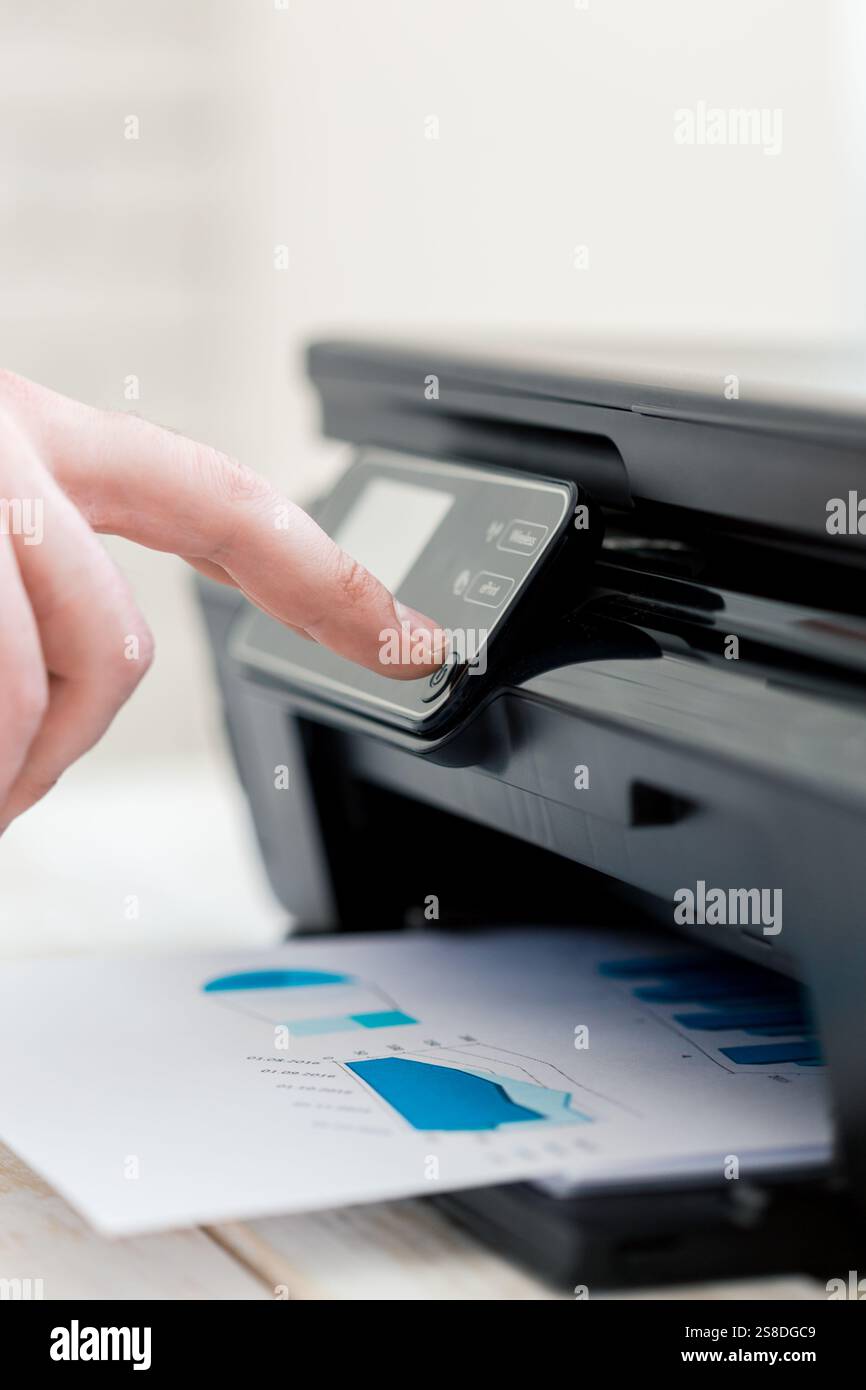 Man's hand making copies. Working with printer Stock Photo - Alamy