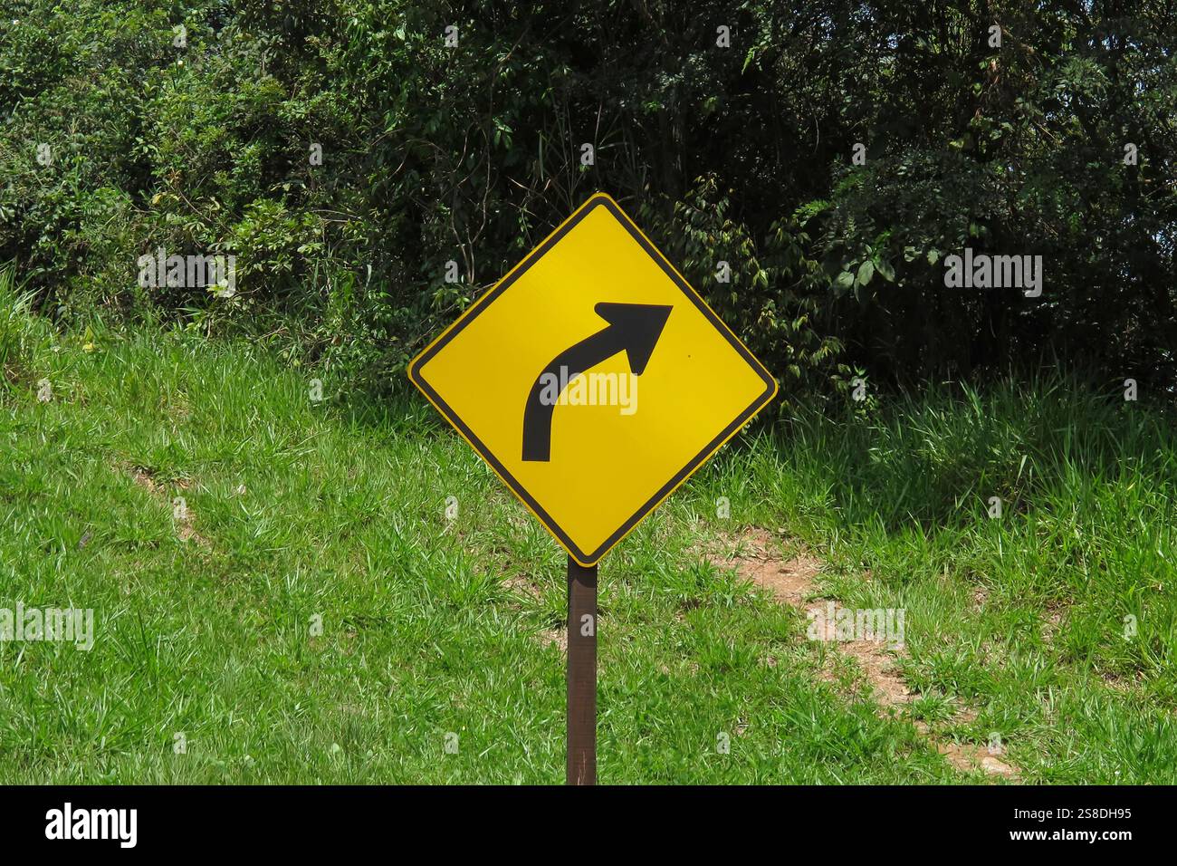 right turn symbol sign - yellow sign sharp curve sign on highway Stock ...