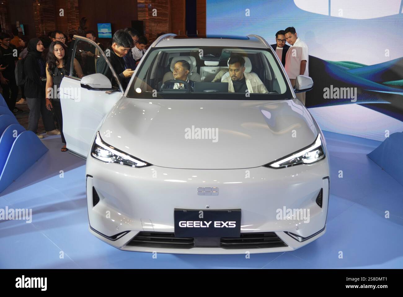 Visitors look to a Geely EX5 electric car during Geely auto brand launch event marking the ...