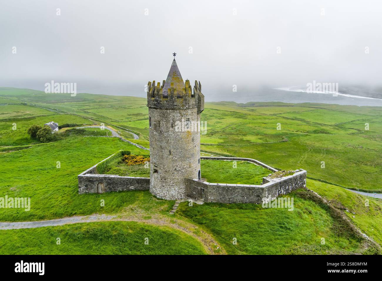 Aerial view of Doonagore Castle, round 16th-century tower house with a ...