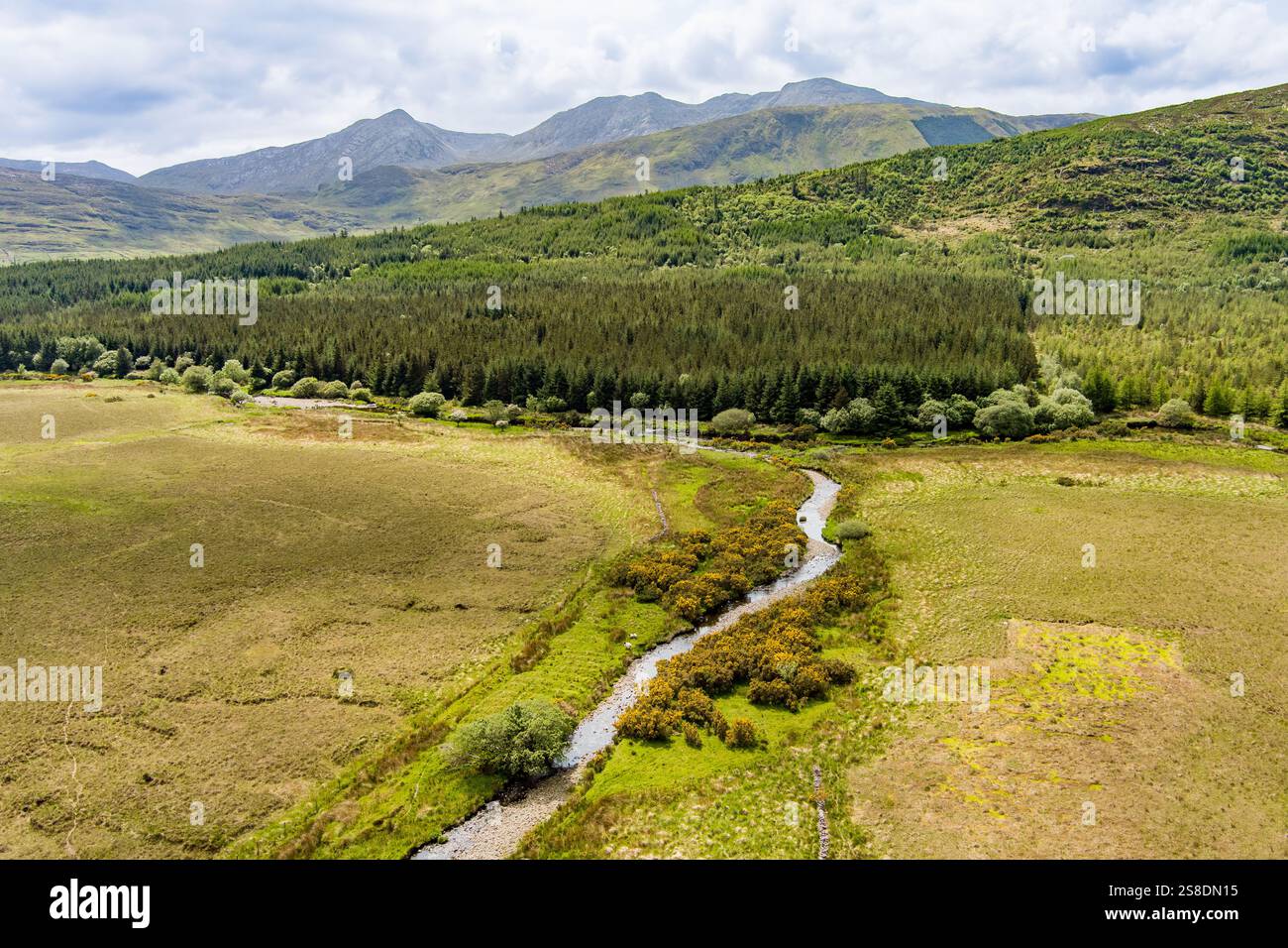 Aerial view of Joyce's river winding down below in Connemara region in ...