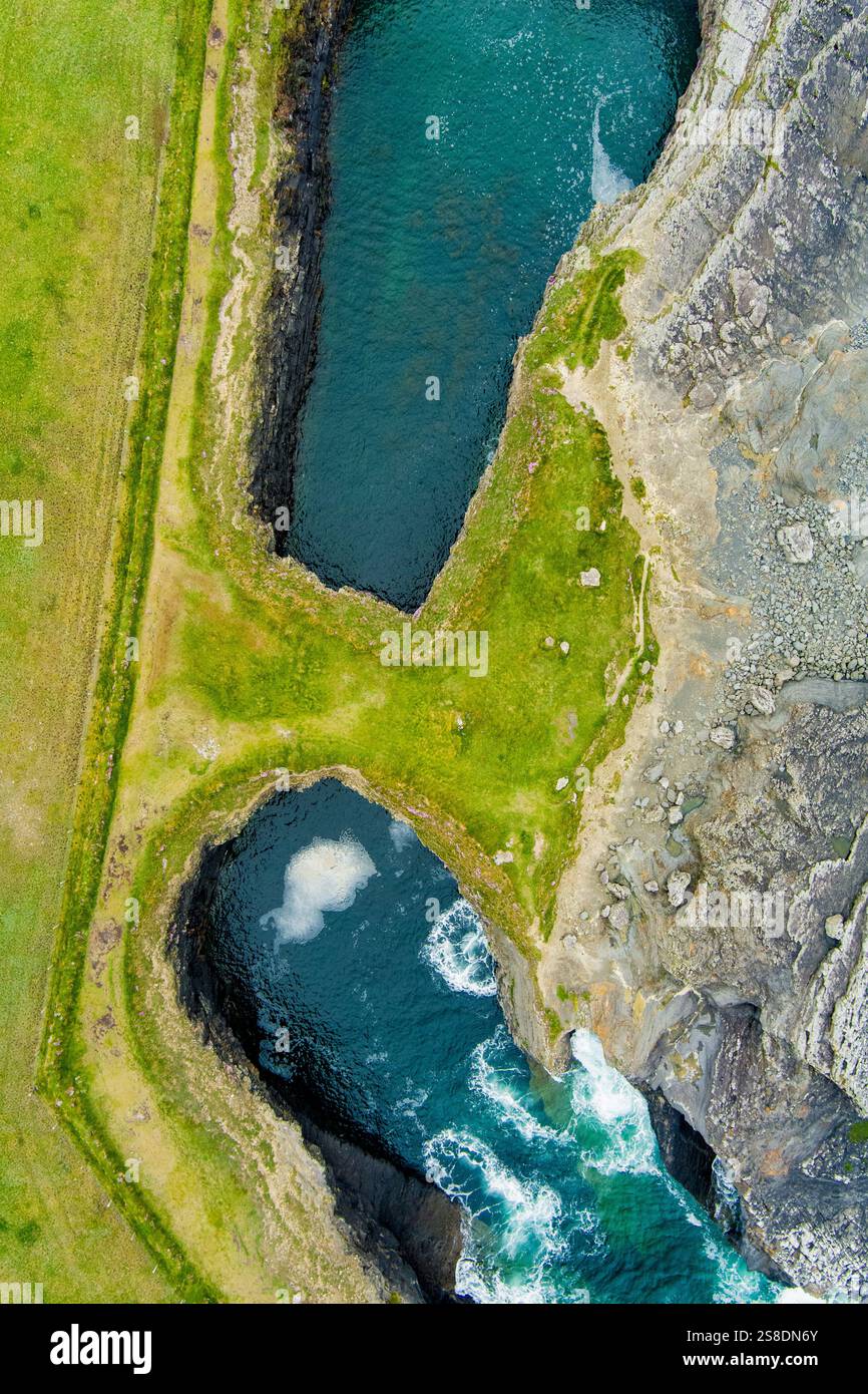 Aerial view of Bridges of Ross, three natural rock arches, carved into ...