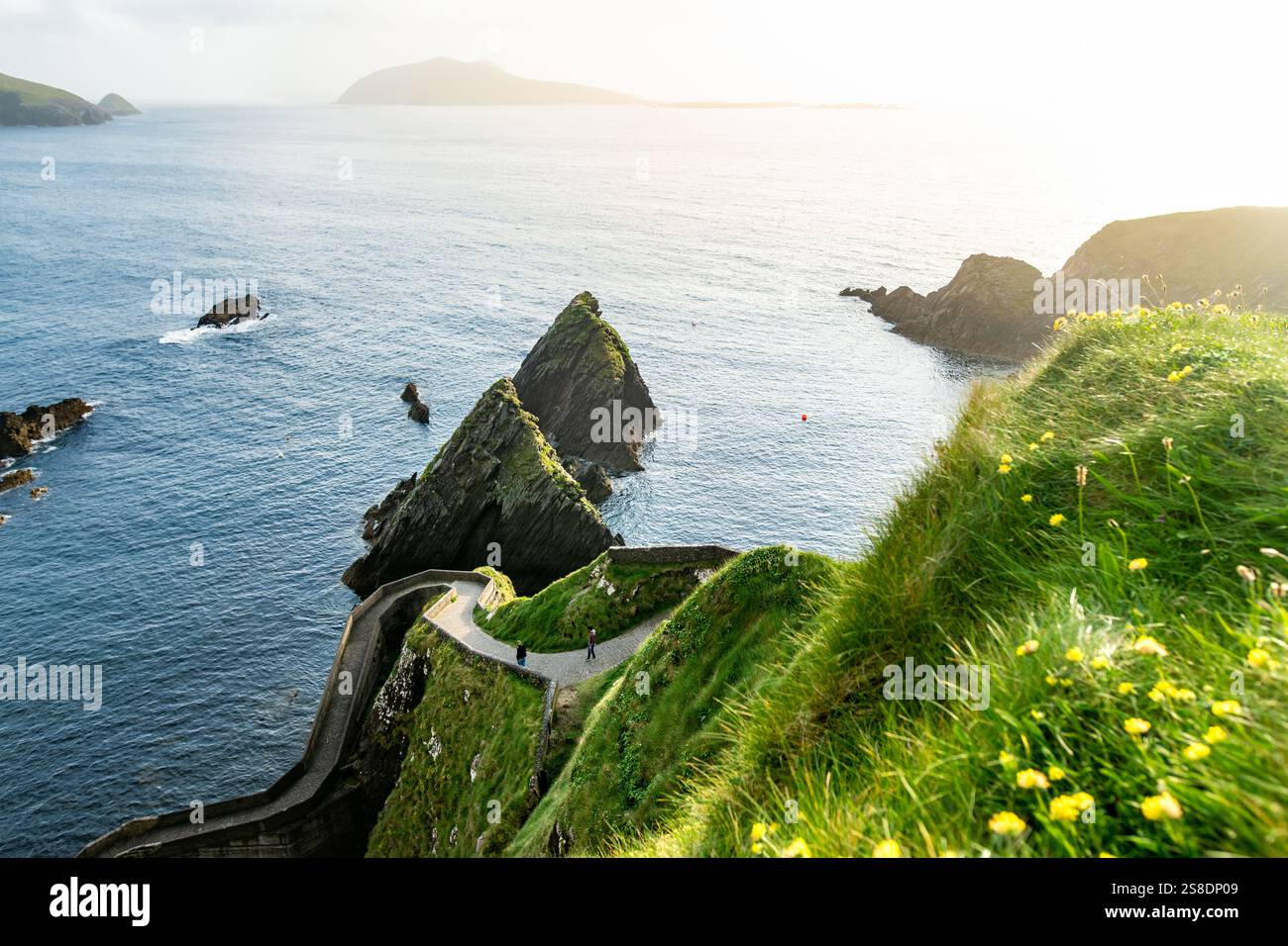 Dunquin or Dun Chaoin pier, Ireland's Sheep Highway. Narrow pathway winding down to the pier ...