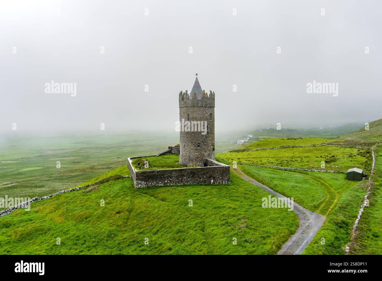 Aerial view of Doonagore Castle, round 16th-century tower house with a ...